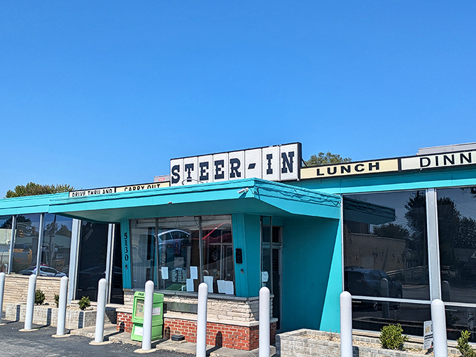 The turquoise time machine! Steer-In's iconic exterior beckons with mid-century charm and the promise of comfort food that's stood the test of time.