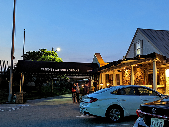 Twilight transforms Creed's into a beacon for hungry travelers. The warm glow from within promises culinary adventures worth writing home about.