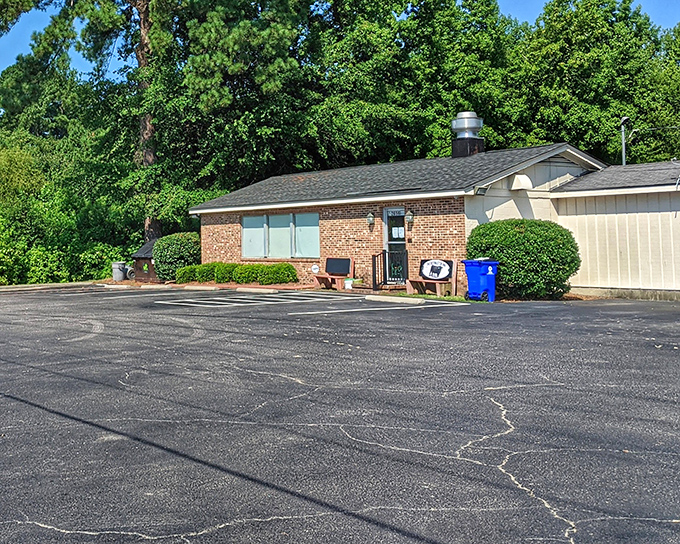 The unassuming exterior belies the culinary magic within. Like finding a treasure chest disguised as a shoebox, this parking lot holds the promise of beef nirvana. 