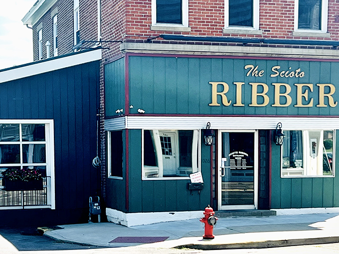The classic brick-and-green exterior might not scream "legendary steakhouse," but that red fire hydrant out front is a fitting warning: flavor emergency ahead!