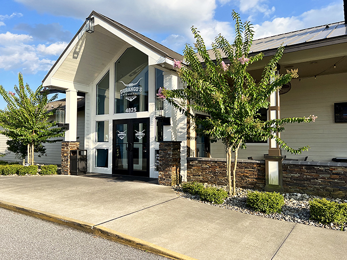 The modern farmhouse exterior hints at the Western charm waiting inside, where steaks take center stage over architectural showboating.