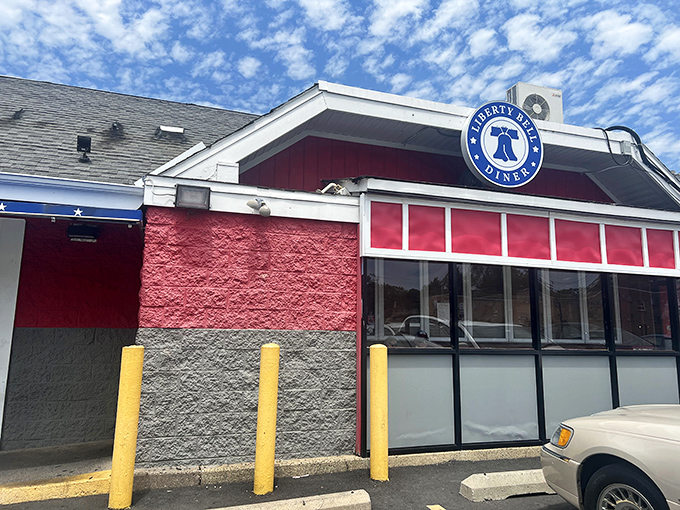 The patriotic red, white, and blue exterior of Liberty Bell Diner stands like a delicious declaration of independence from boring food.