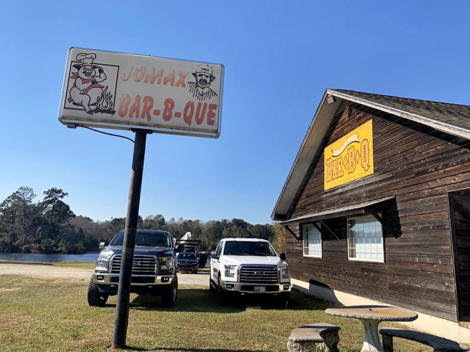 The classic roadside BBQ sign beckons like a smoky siren call. Pickup trucks in the lot tell you everything you need to know &ndash; locals approve.