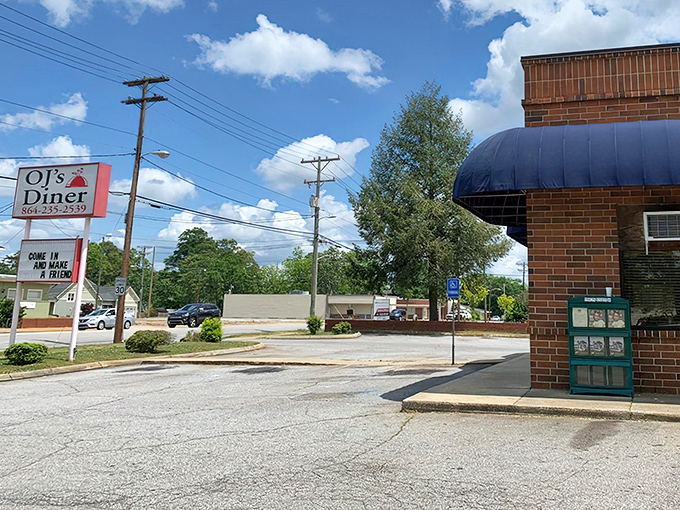 Bathed in sunshine, OJ's modest storefront stands as a testament to the timeless truth: the less fancy the sign, the better the food inside.