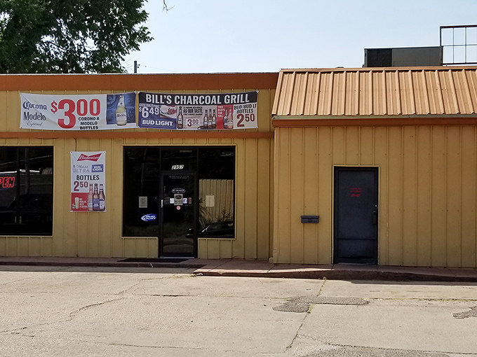 The unassuming yellow exterior of Bill's Charcoal Grill proves once again that culinary treasures often hide in plain sight.