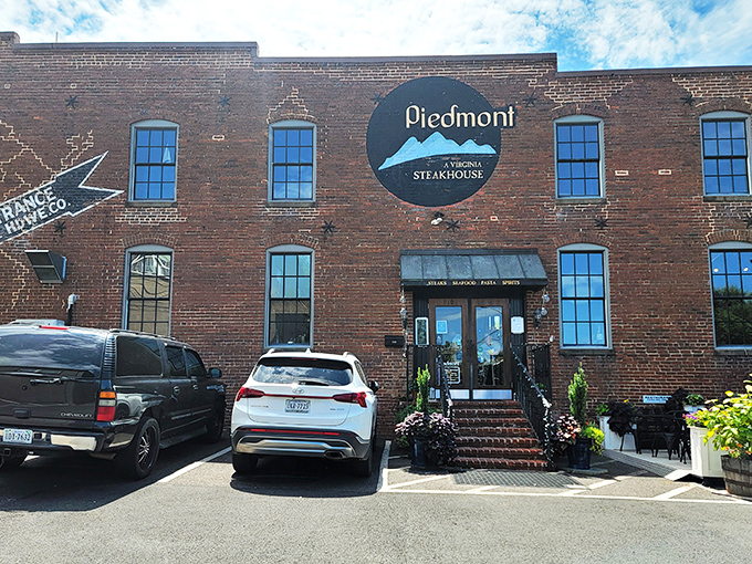 Historic brick charm meets modern culinary excellence at Piedmont Steakhouse's exterior, where Virginia's Blue Ridge Mountains inspire both the logo and the cuisine.