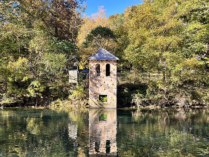 The iconic stone water tower stands like a fairy tale sentinel, its reflection dancing in waters so clear you'd think Mother Nature hired a cleaning service.