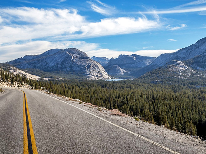 The road to heaven has double yellow lines. Tioga Pass unfurls before you like nature's red carpet, inviting you into a world where granite peaks touch the sky.