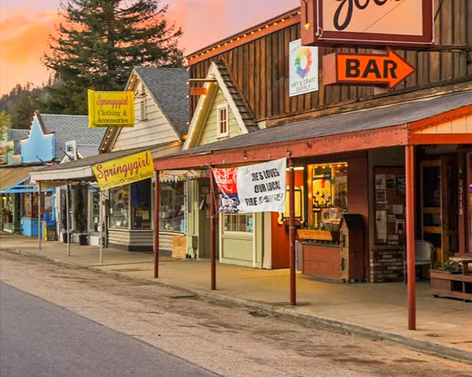Downtown Boulder Creek at sunset, where wooden storefronts glow amber under mountain twilight. The perfect small-town main street that time politely decided to leave alone.