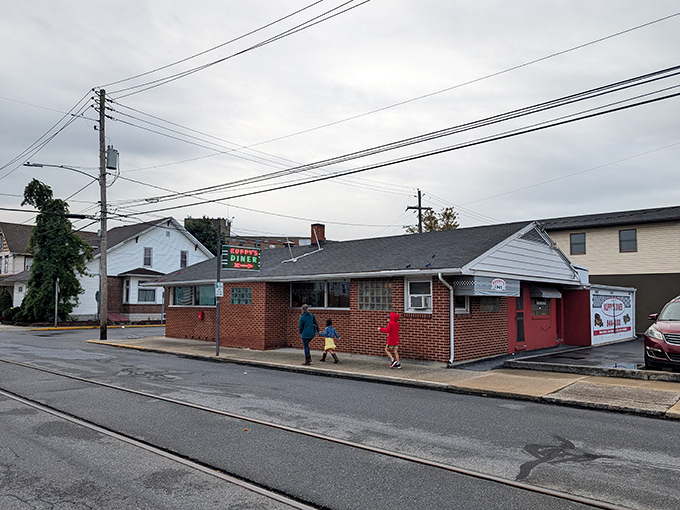 The unassuming brick exterior of Kuppy's Diner stands like a time capsule on Brown Street, promising comfort food that transcends decades.