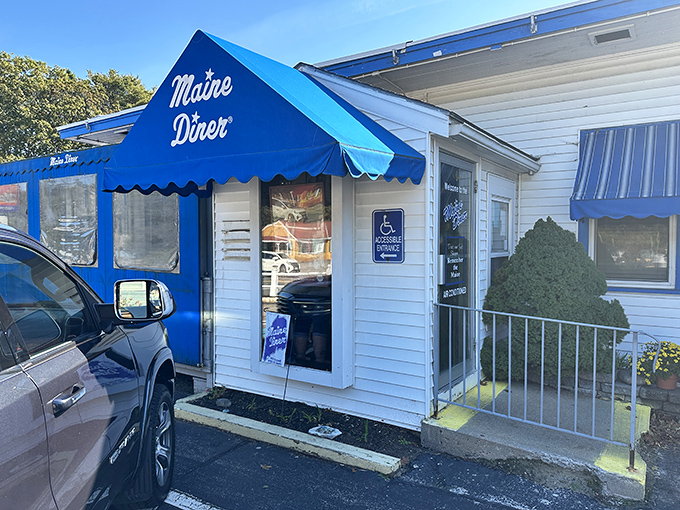 That cheerful blue awning isn't just decoration—it's a beacon calling hungry travelers to seafood paradise on Route 1.