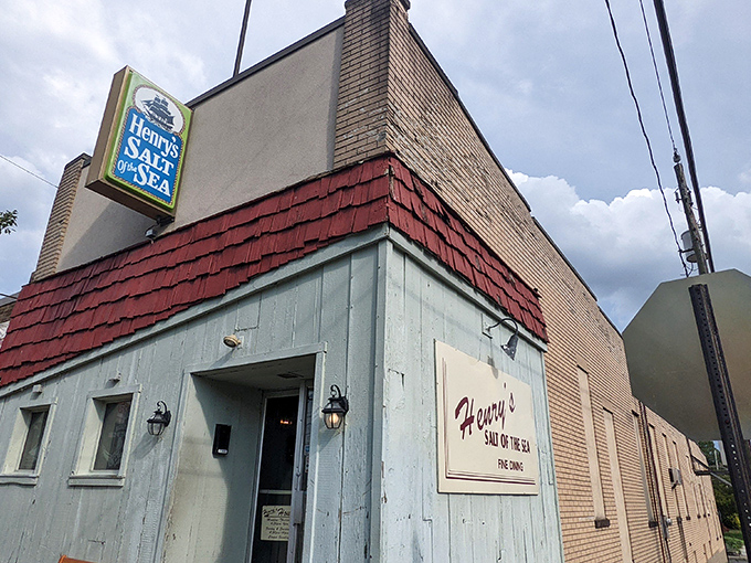 Henry's Salt of the Sea's mint-green exterior with vibrant red shingles stands like a seafood oasis in Allentown's urban landscape.