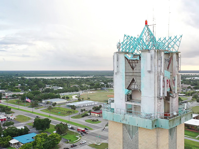 The iconic Happiness Tower stands sentinel over Lake Placid, its turquoise crown a beacon of quirky charm in this hidden Florida gem.