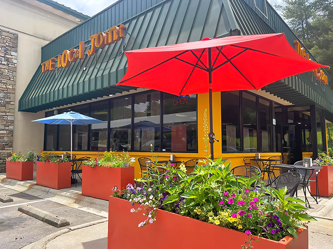 The Local Joint's cheerful exterior welcomes hungry travelers with vibrant planters and a promise of comfort food that'll make your taste buds dance.