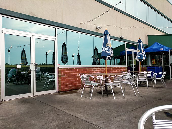 Outdoor seating that invites lingering conversations. Those blue umbrellas aren't just for show—they're signaling "relaxation station ahead."
