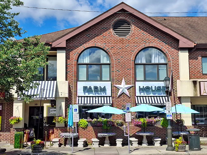 The brick facade of Farmhouse Crystal stands proudly in East Stroudsburg, its star emblem and blue umbrellas beckoning hungry travelers like a culinary lighthouse.