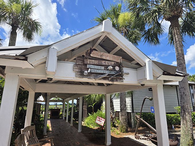 The welcoming entrance to Skippers' Fish Camp beckons like a coastal siren song, promising seafood treasures under that charming white pavilion.