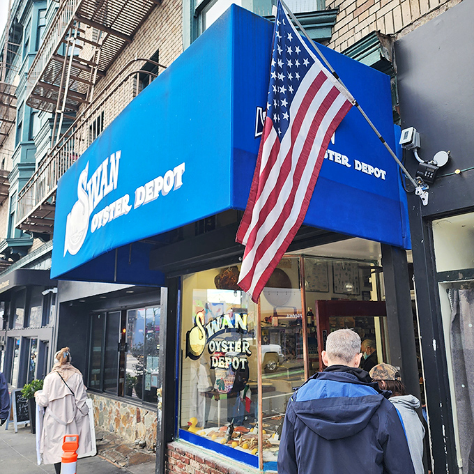 The iconic blue awning of Swan Oyster Depot stands out like a maritime beacon on Polk Street, promising seafood treasures to those patient enough to wait.