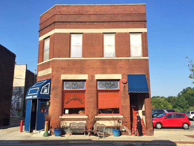 The brick facade of The Courier Cafe stands proudly on Race Street, its blue awning like a beacon to hungry travelers seeking breakfast salvation.