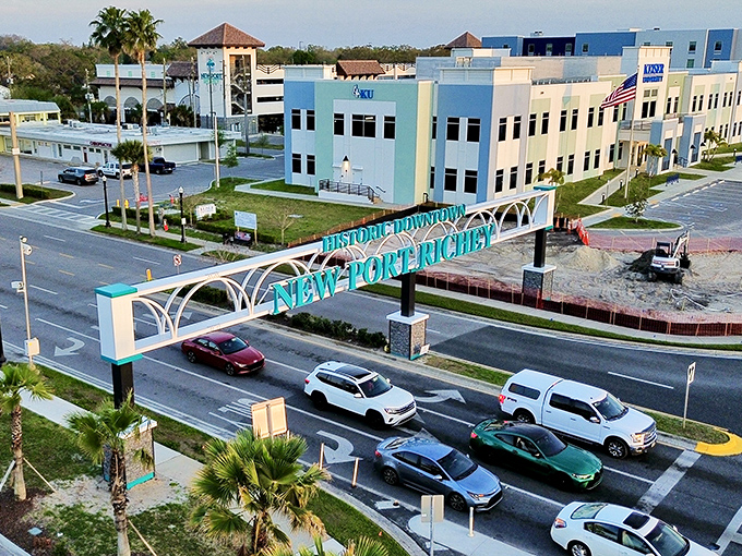 The "Historic Downtown New Port Richey" sign welcomes visitors with pastel-colored buildings behind it &ndash; Florida charm without the tourist markup.