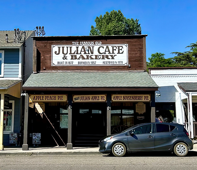 The historic Julian Cafe & Bakery stands proudly on Main Street, a wooden time capsule promising apple pie dreams and hearty mountain breakfasts.
