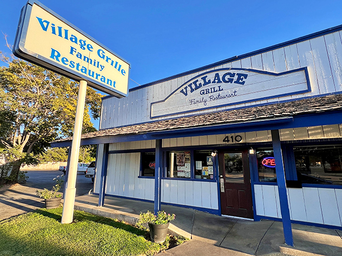 The blue and white exterior of Village Cafe stands like a beacon of breakfast hope in Tehachapi, promising comfort food that doesn't need fancy frills to impress.
