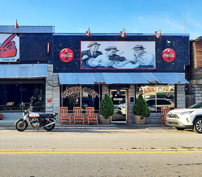 The iconic facade of Ozark Cafe welcomes hungry travelers with its vintage mural and rocking chairs &ndash; small-town Arkansas hospitality at its most authentic.