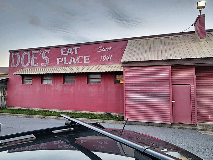 The pink fortress of flavor! Doe's Eat Place in Bentonville stands out like a carnivore's beacon, promising meaty treasures behind its unassuming doors.