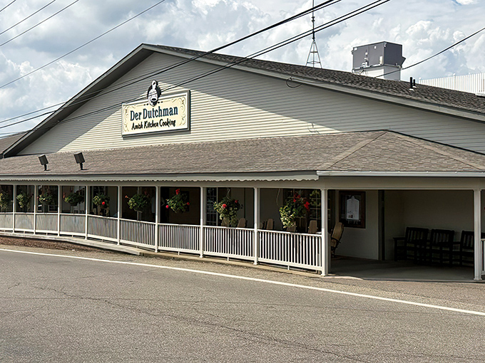 The welcoming front porch of Der Dutchman beckons like a grandmother's hug, complete with hanging flower baskets that could win garden club competitions.