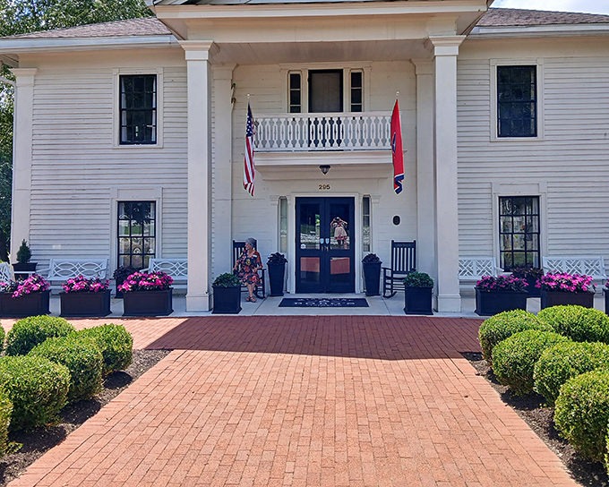 Pink flowers add a splash of color to this pristine white Southern belle of a building. Like finding the perfect accessory for a classic outfit, these blooms complete the picture.