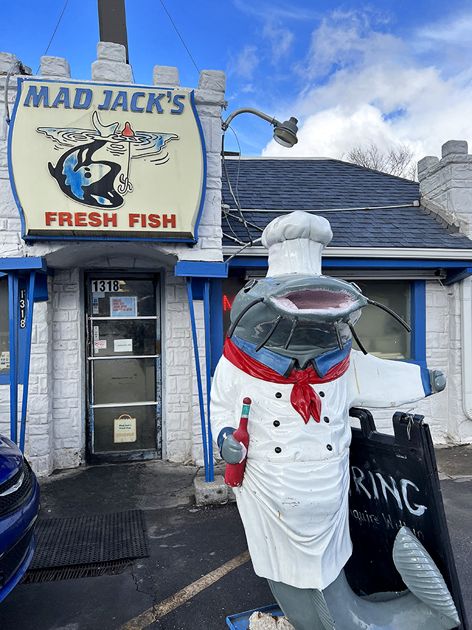 Outside stands a cheerful chef statue, welcoming you to a place where fresh fish dreams come true.