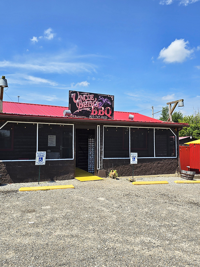 The humble red-roofed exterior of Uncle Beth's BBQ stands like a beacon for smoke-seekers, promising authentic flavors behind its unassuming fa&ccedil;ade.