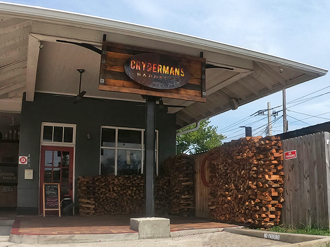 The woodpile outside Crydermans isn't decoration—it's a promise of smoky deliciousness to come. This is barbecue that takes no shortcuts.