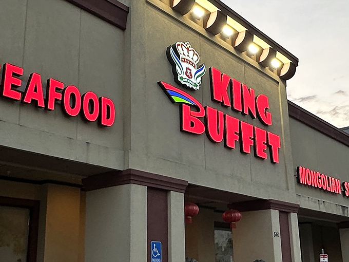 Same exterior shot from a slightly different angle, showing the bold red signage against the neutral building. The Chinese lanterns hint at culinary adventures awaiting inside.