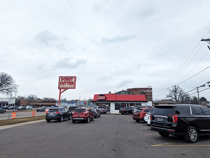 The red-roofed beacon of breakfast bliss stands proudly on its corner, parking lot filled with devotees making their morning pilgrimage to donut paradise.