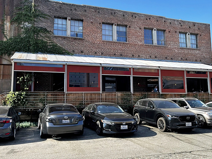 Bestia's unassuming brick exterior hides culinary treasures within, like finding a Michelin star in your neighborhood garage. The red awnings offer the only hint of the flavor explosion waiting inside.