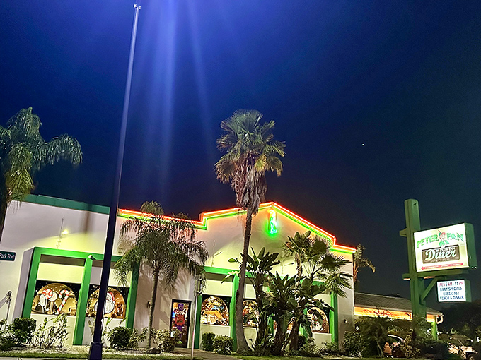 Peter Pan Diner's neon glow transforms the Oakland Park night into a beacon for breakfast lovers. Like a culinary lighthouse guiding hungry souls home.