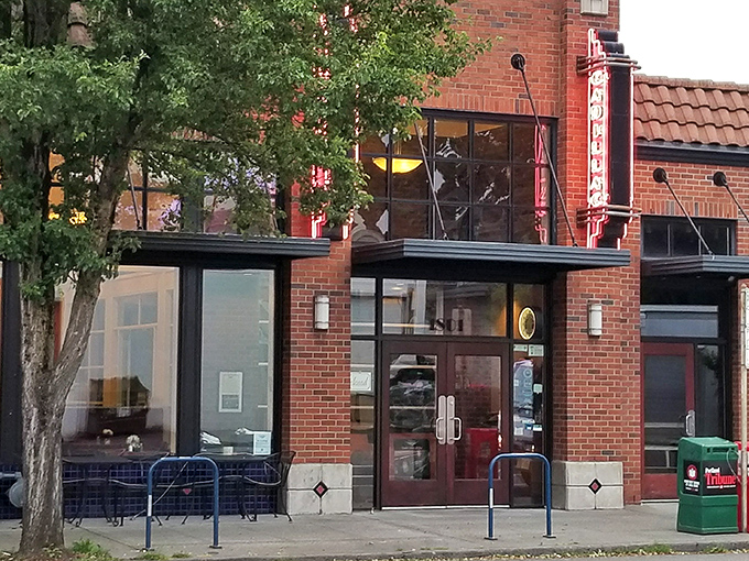 The brick exterior of Cadillac Caf&eacute; stands like a culinary lighthouse on Northeast Broadway, beckoning hungry souls with its vintage neon sign.