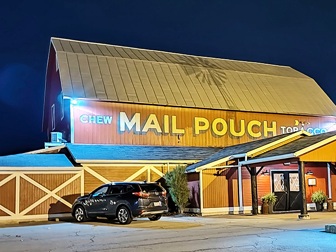 The iconic red barn glows like a beacon for hungry travelers at night, the "Mail Pouch Tobacco" sign a nostalgic nod to Ohio's rural heritage.