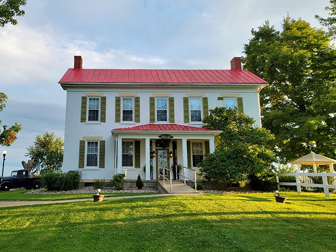 The Farm Restaurant's historic white farmhouse with distinctive red roof stands proudly against Ohio's countryside, inviting diners to a memorable culinary journey.