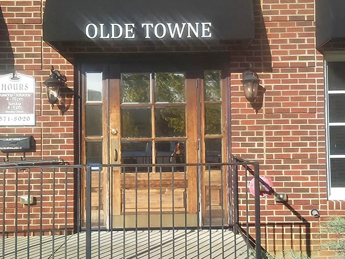 The timeless brick facade and simple black awning of Olde Towne whisper confidence without the flash—because places like this let the food do all the talking.