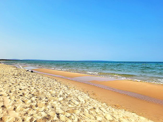 The view that makes you question why you ever bothered with Caribbean vacations. Esch Beach's pristine shoreline meets Lake Michigan's endless blue horizon.