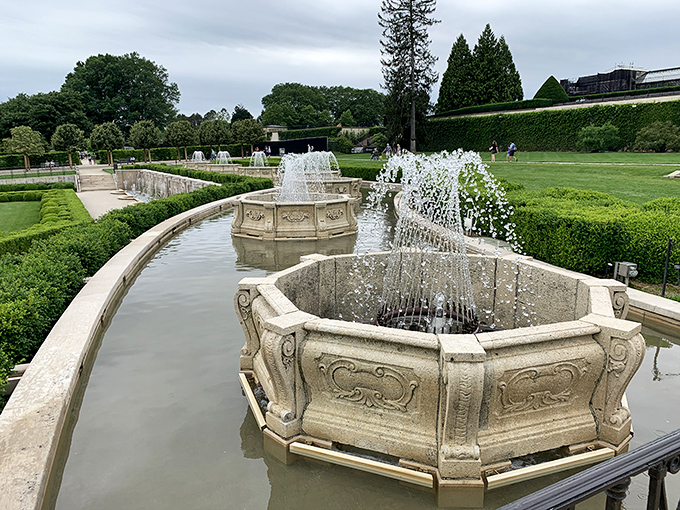Limestone basins cascade like stepping stones through history, their elegant carvings whispering tales of European grandeur while water dances playfully in the Pennsylvania sunshine.