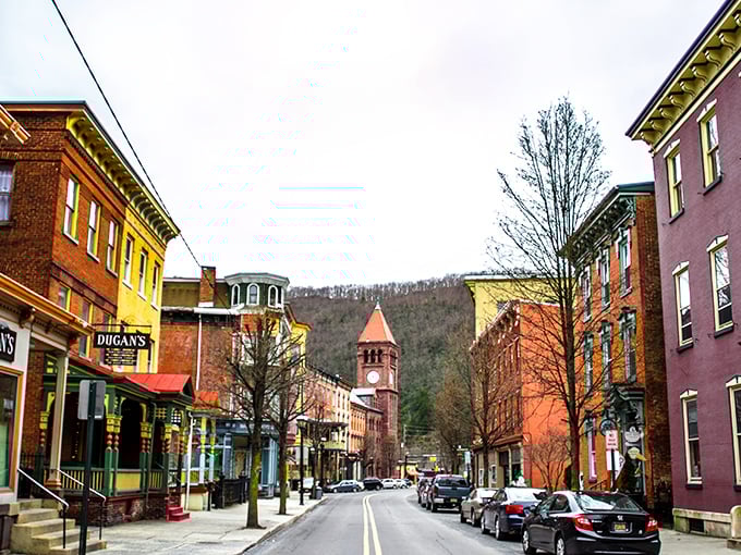Broadway stretches toward the mountains like a timeline of American architecture, where colorful storefronts beckon with promises of treasures within.