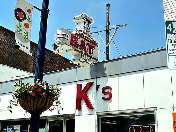 That vintage neon "EAT" sign isn't just advertising – it's a time portal to when diners were America's living rooms with better coffee.