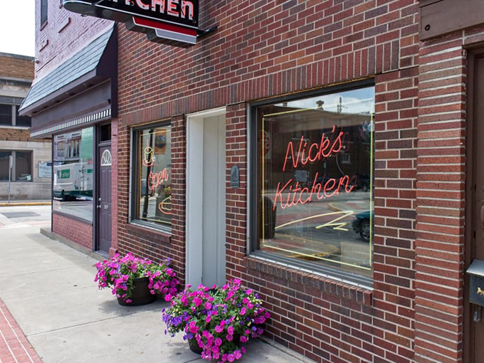 The brick facade of Nick's Kitchen stands as a humble guardian of culinary treasures, its neon sign a beacon for hungry Hoosiers seeking comfort food perfection.
