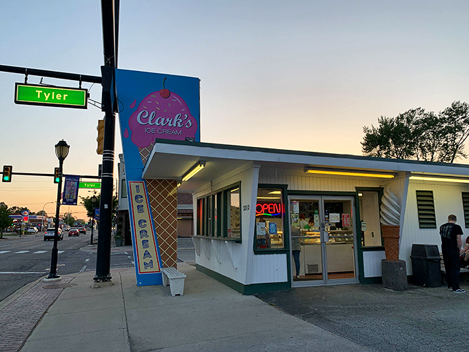 The corner of nostalgia and deliciousness! Clark's iconic storefront glows at dusk, beckoning ice cream lovers with its vintage charm and promise of sweet relief.