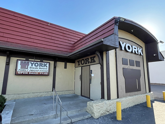 The unassuming exterior of York Steak House stands like a culinary time capsule in Columbus, its burgundy roof and modest signage promising nostalgic delights within.