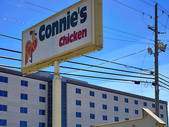 The iconic Connie's Chicken sign stands tall against the Mississippi sky, a beacon of comfort food that's been calling hungry travelers home for generations.