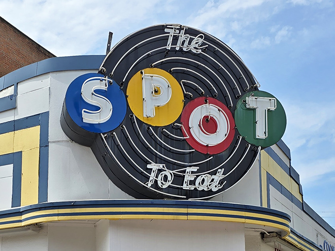 The iconic neon sign of The Spot beckons hungry travelers with its colorful circles &ndash; a retro beacon of comfort food promising in downtown Sidney.
